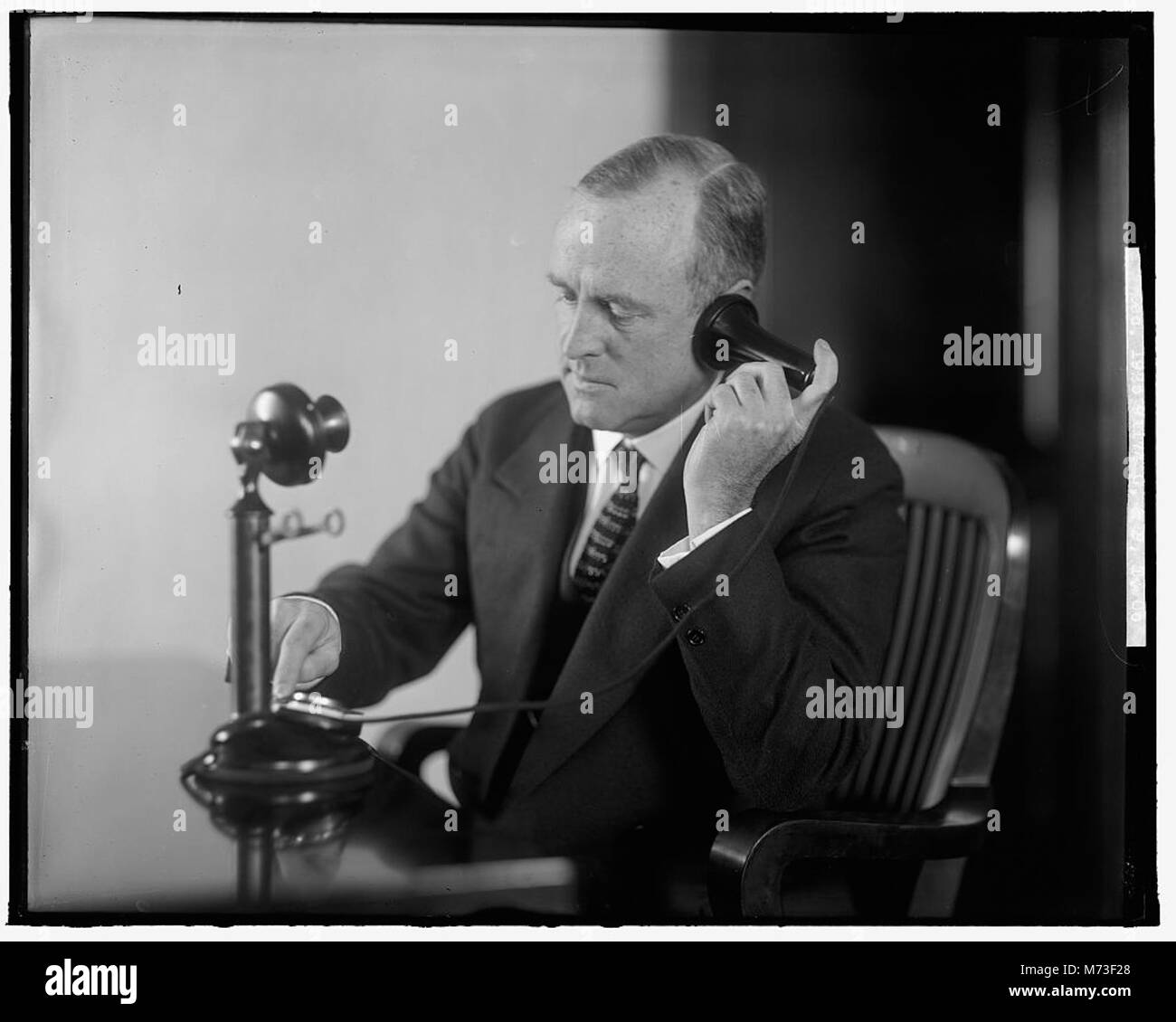 This photograph shows a man using a telephone at the C & P Telephone ...