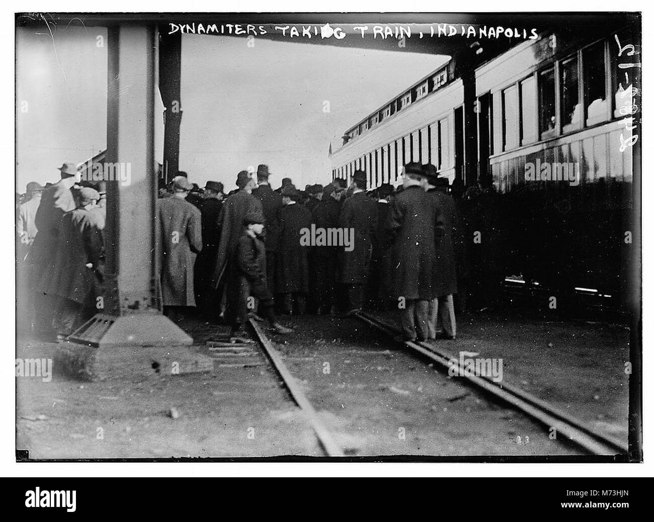 This photograph captures a group of dynamiters boarding a train in ...