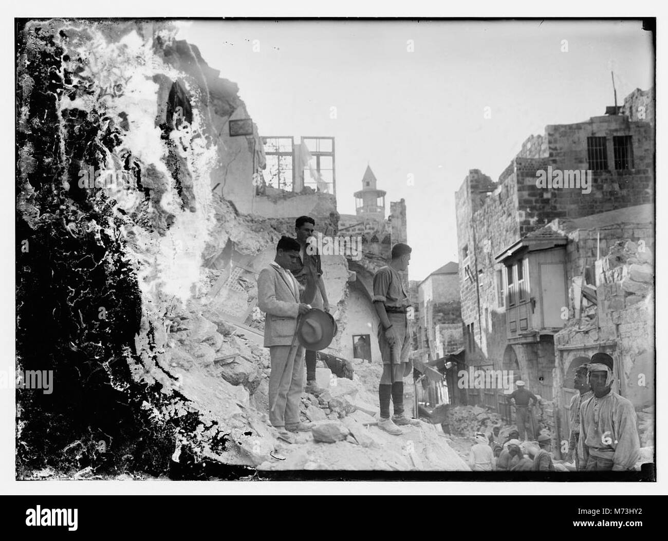 The image depicts significant earthquake damage, showcasing structural ...