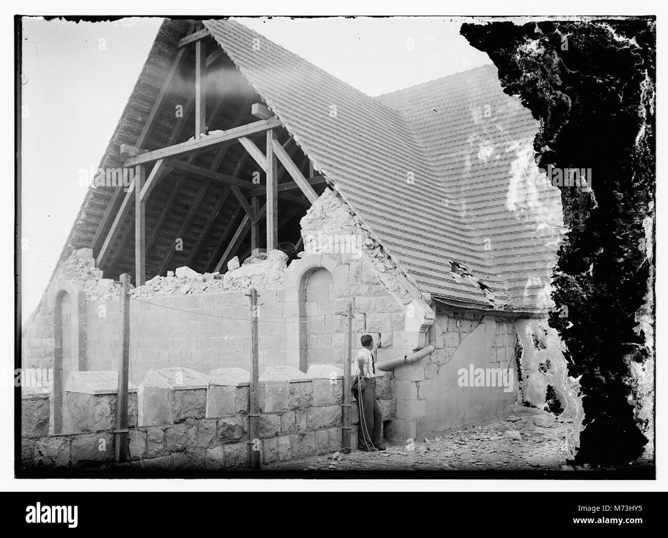 This image shows the aftermath of an earthquake, documenting the damage ...