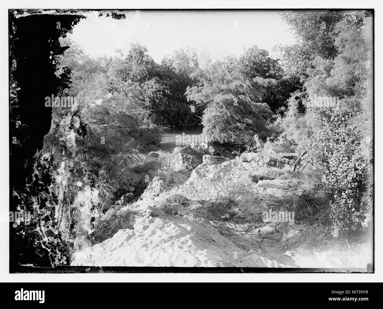 The image shows an earthquake-induced rift along the banks of a river ...