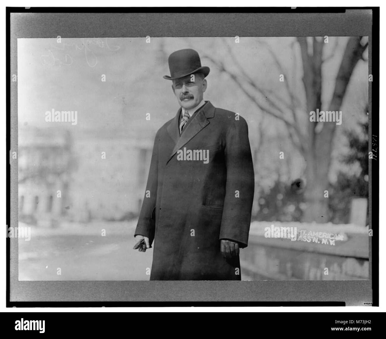 A half-length portrait of Edward Thomas Taylor, shown standing outdoors ...