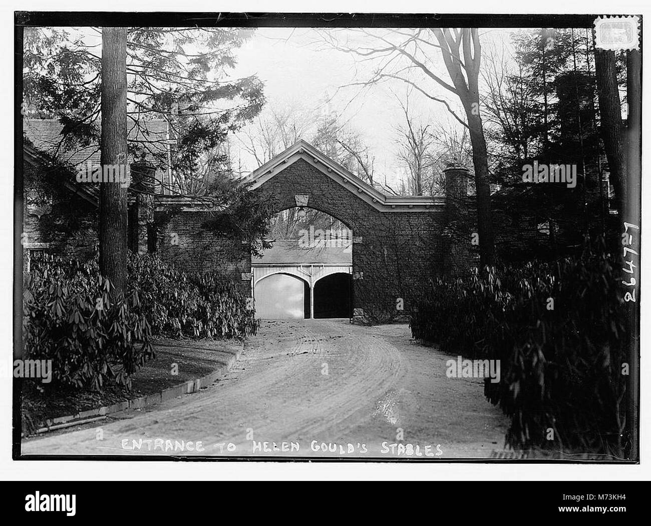 A historical photograph of the entrance to Helen Gould's stables. This ...