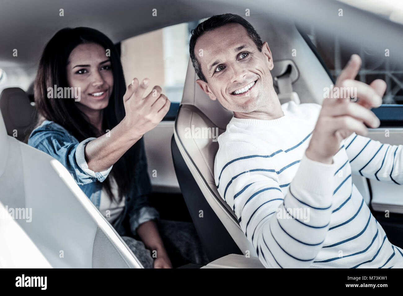 Positive happy man pointing with his hand Stock Photo - Alamy
