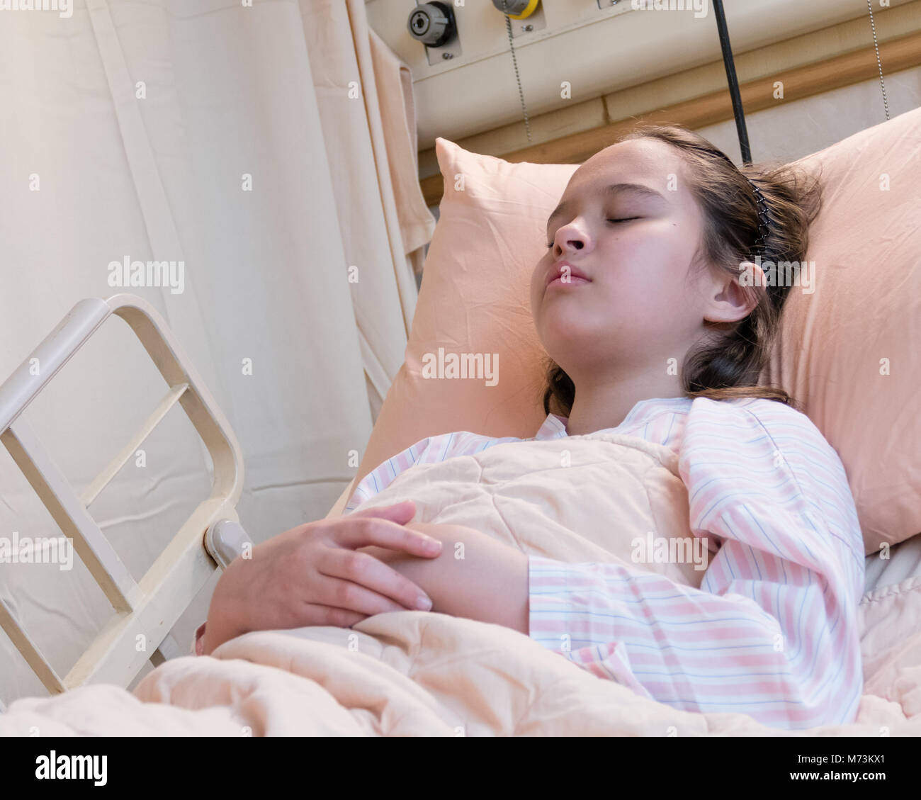 Young girl recovering from illness in hospital bed Stock Photo - Alamy