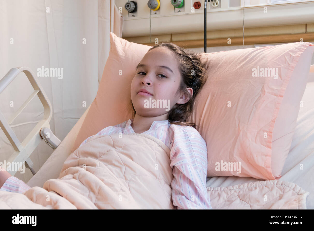 Young girl recovering from illness in hospital bed Stock Photo - Alamy