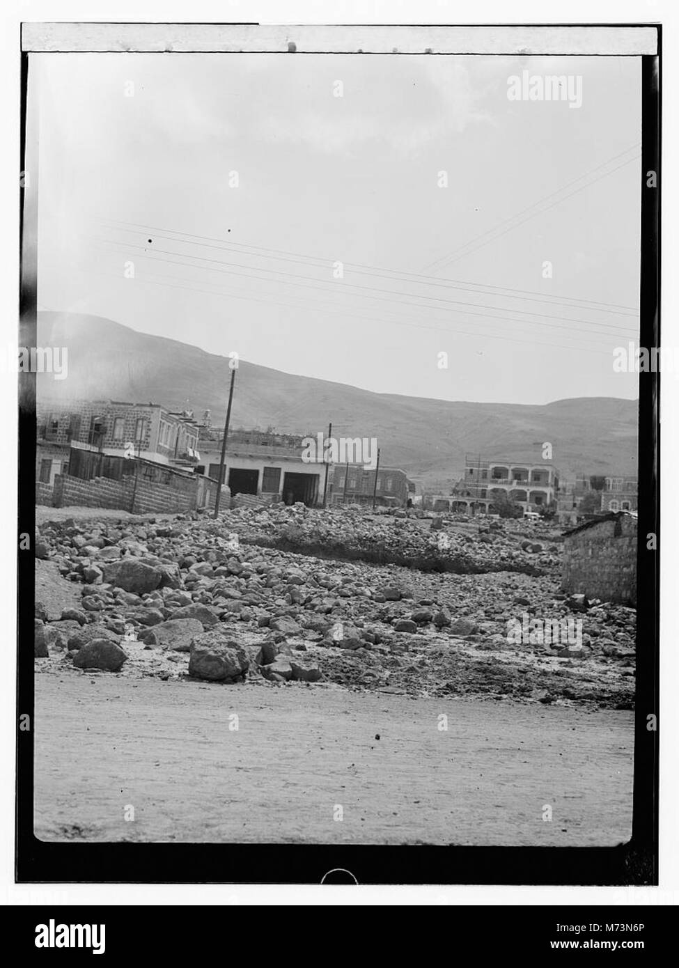 A photograph documenting flood and war damage, illustrating the effects ...