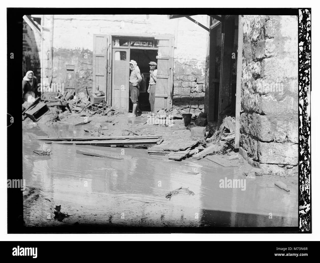This image shows the aftermath of a flood and war damage in an ...