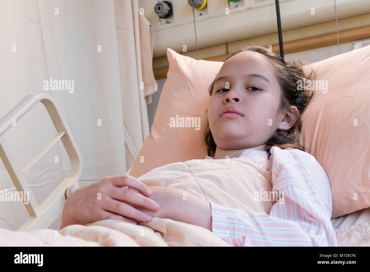 Young girl recovering from illness in hospital bed Stock Photo - Alamy