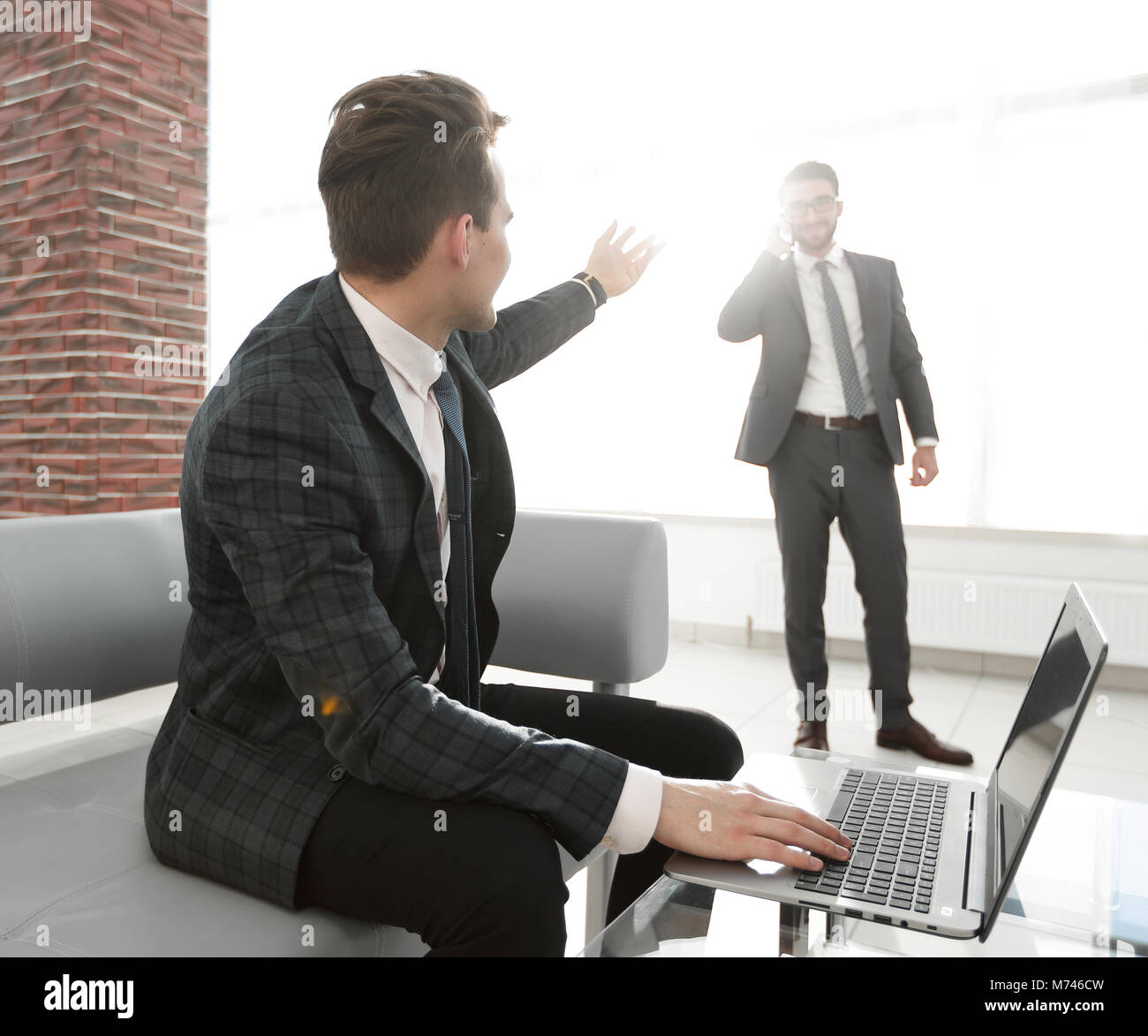 businessman with laptop pointing at the screen Stock Photo - Alamy