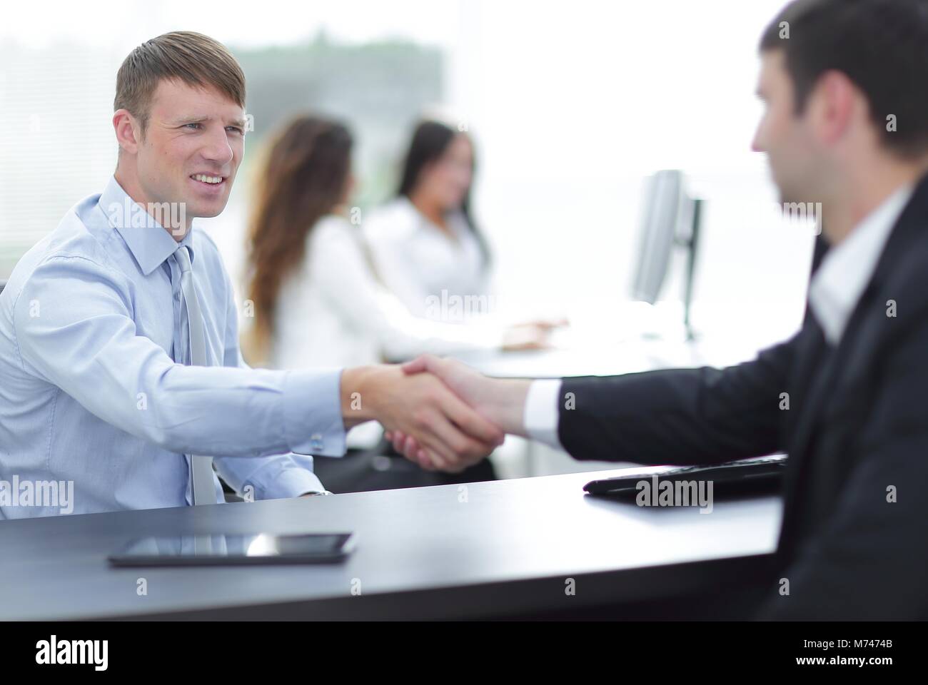handshake business partners at your Desk Stock Photo - Alamy