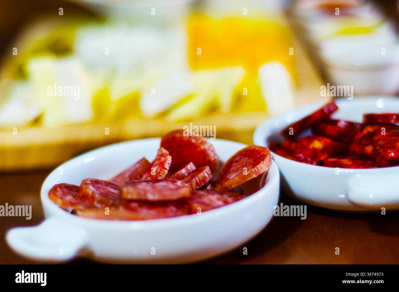 set of traditional Spanish sausages, side dishes of thinly sliced ...
