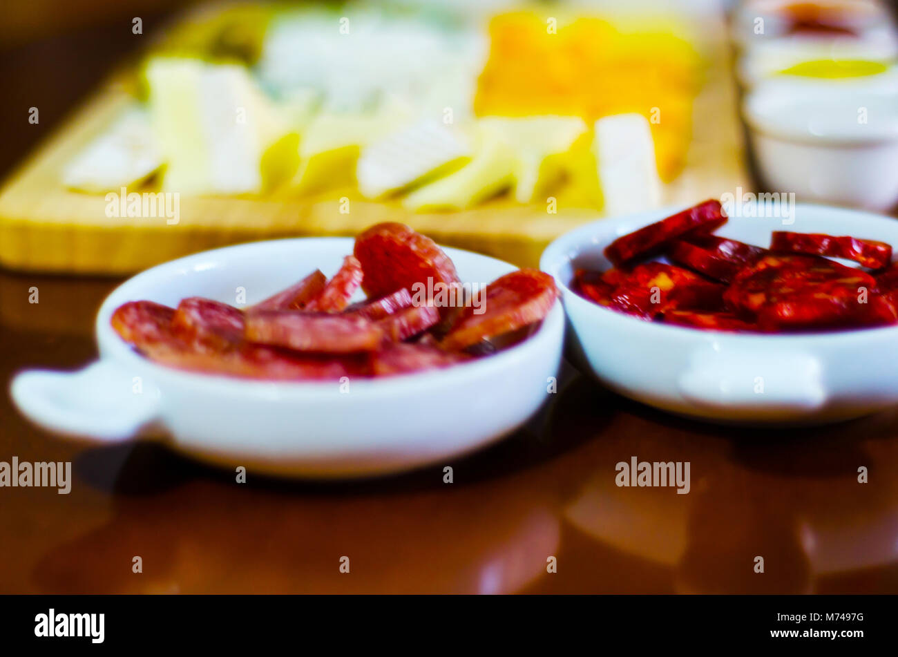 set of traditional Spanish sausages, side dishes of thinly sliced ...