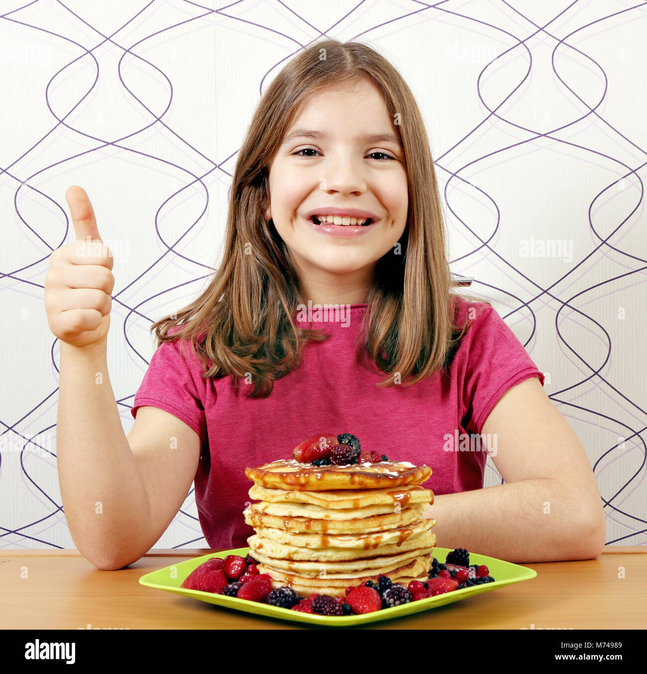 happy little girl with panckaces dessert and thumb up Stock Photo - Alamy