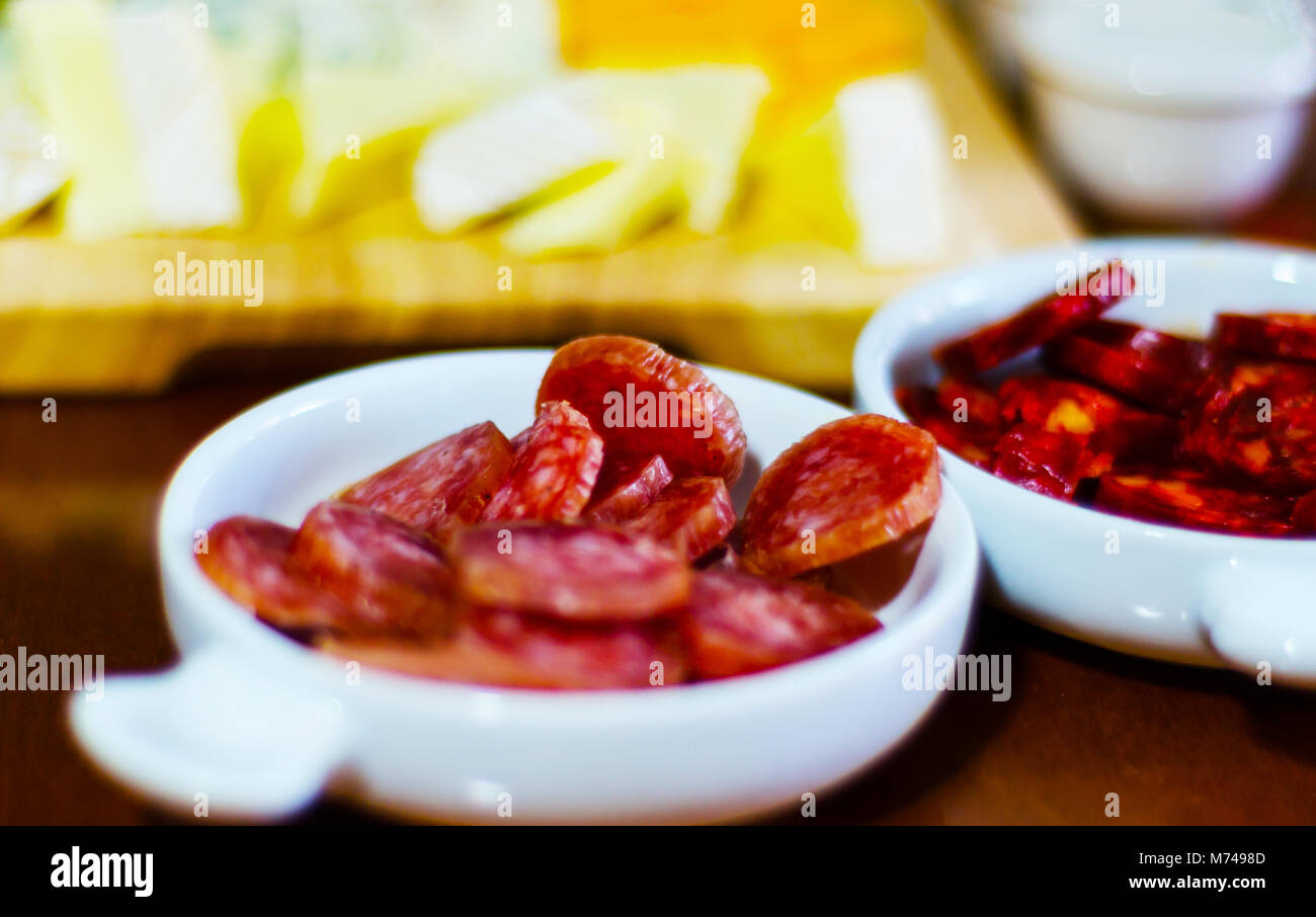 set of traditional Spanish sausages, side dishes of thinly sliced ...