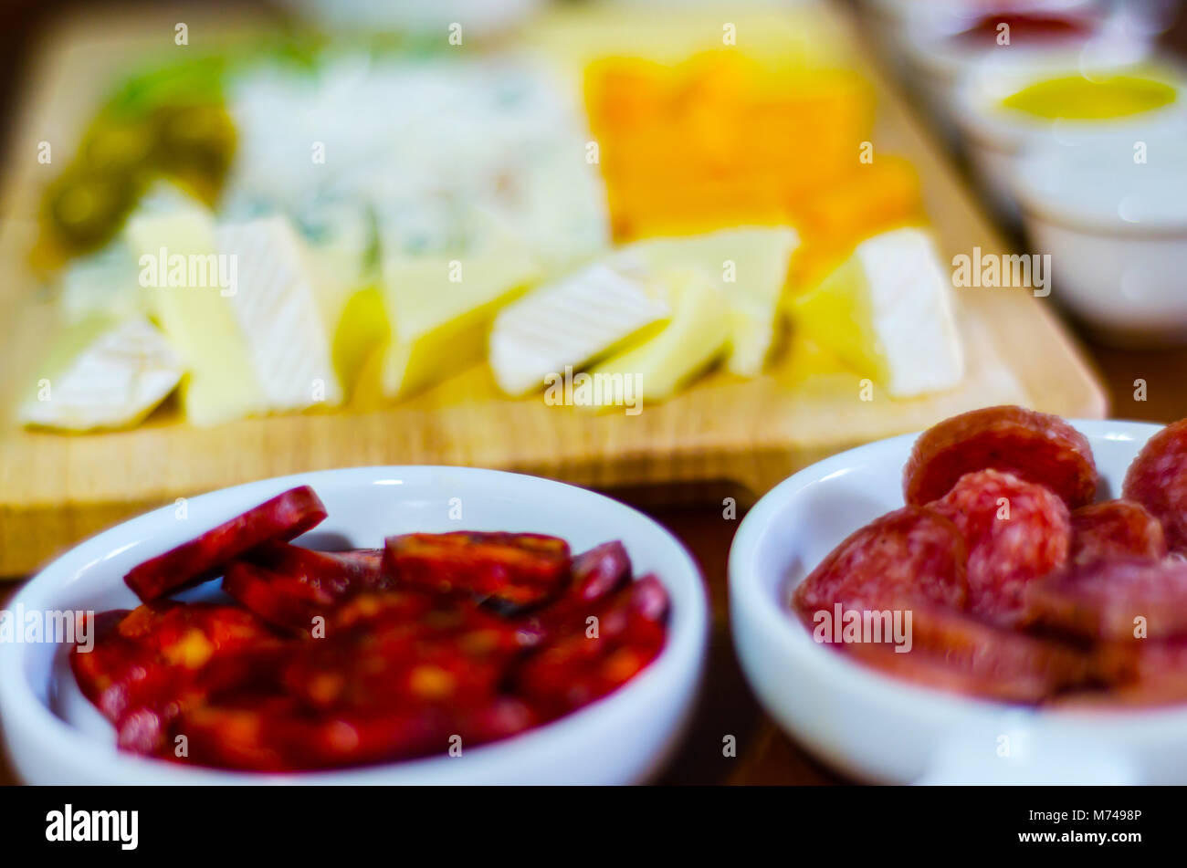 set of traditional Spanish sausages, side dishes of thinly sliced ...