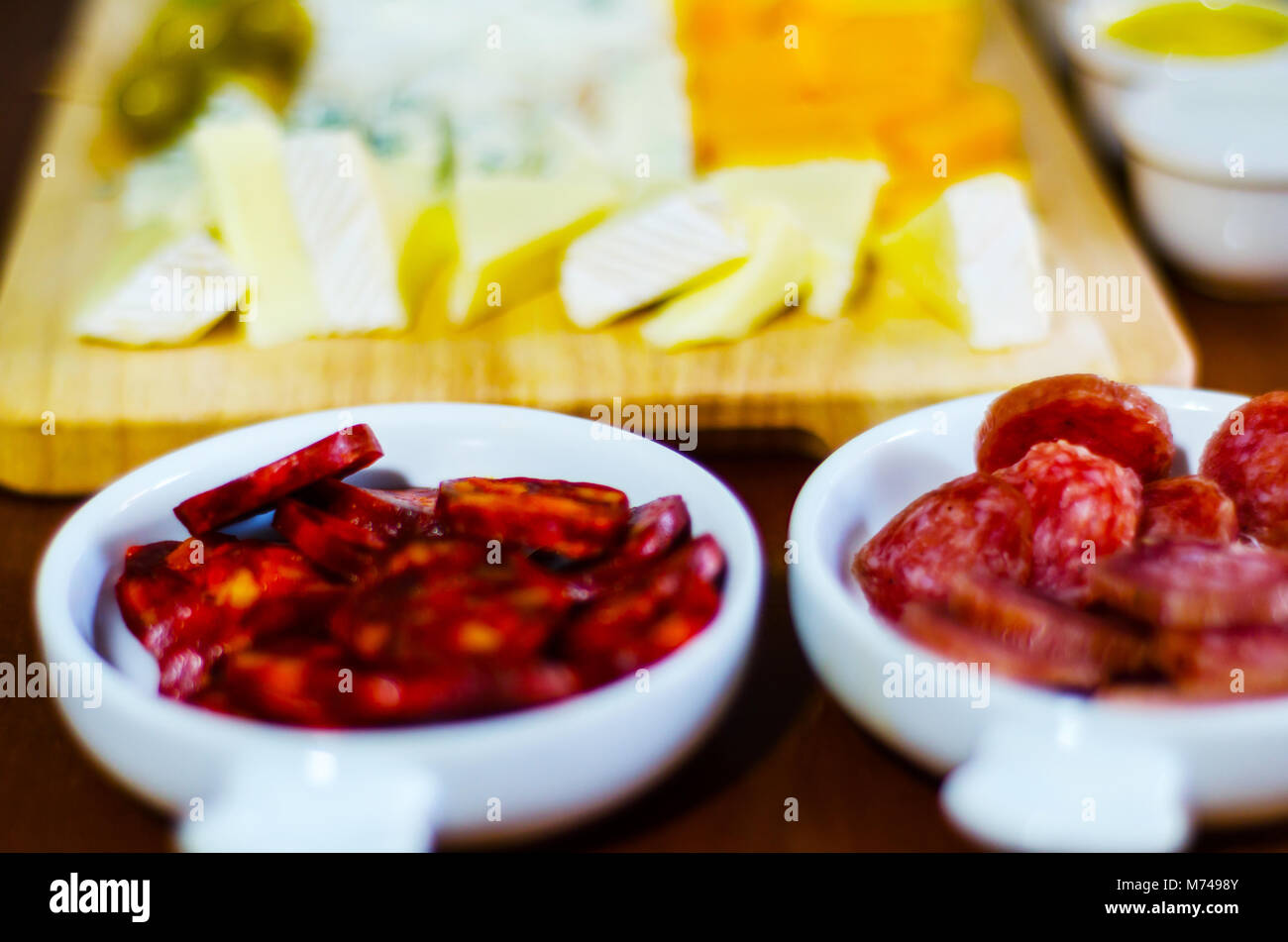 set of traditional Spanish sausages, side dishes of thinly sliced ...