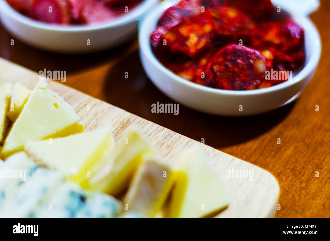 set of traditional Spanish sausages, side dishes of thinly sliced ...
