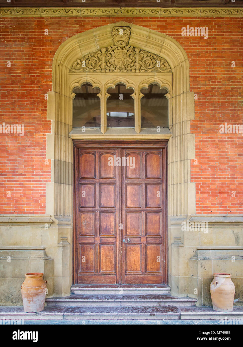 Victorian era doors in the brick antique castle wall Stock Photo - Alamy