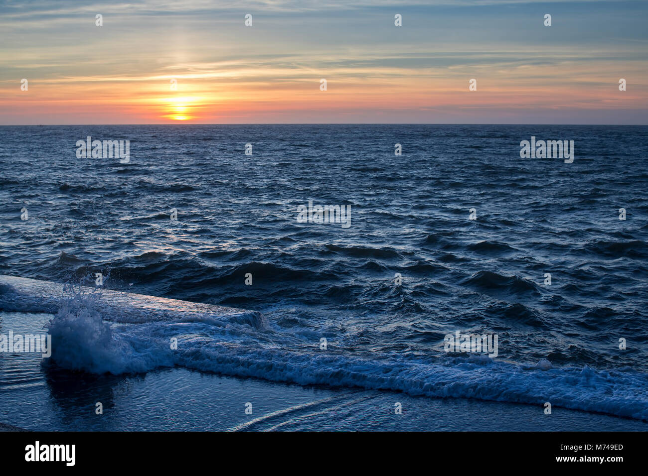 Waterfront ocean surf during amazing sunset Stock Photo - Alamy