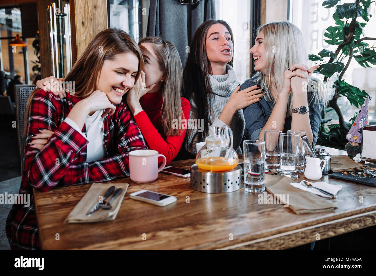 four friends gossiping in a cafe Stock Photo - Alamy