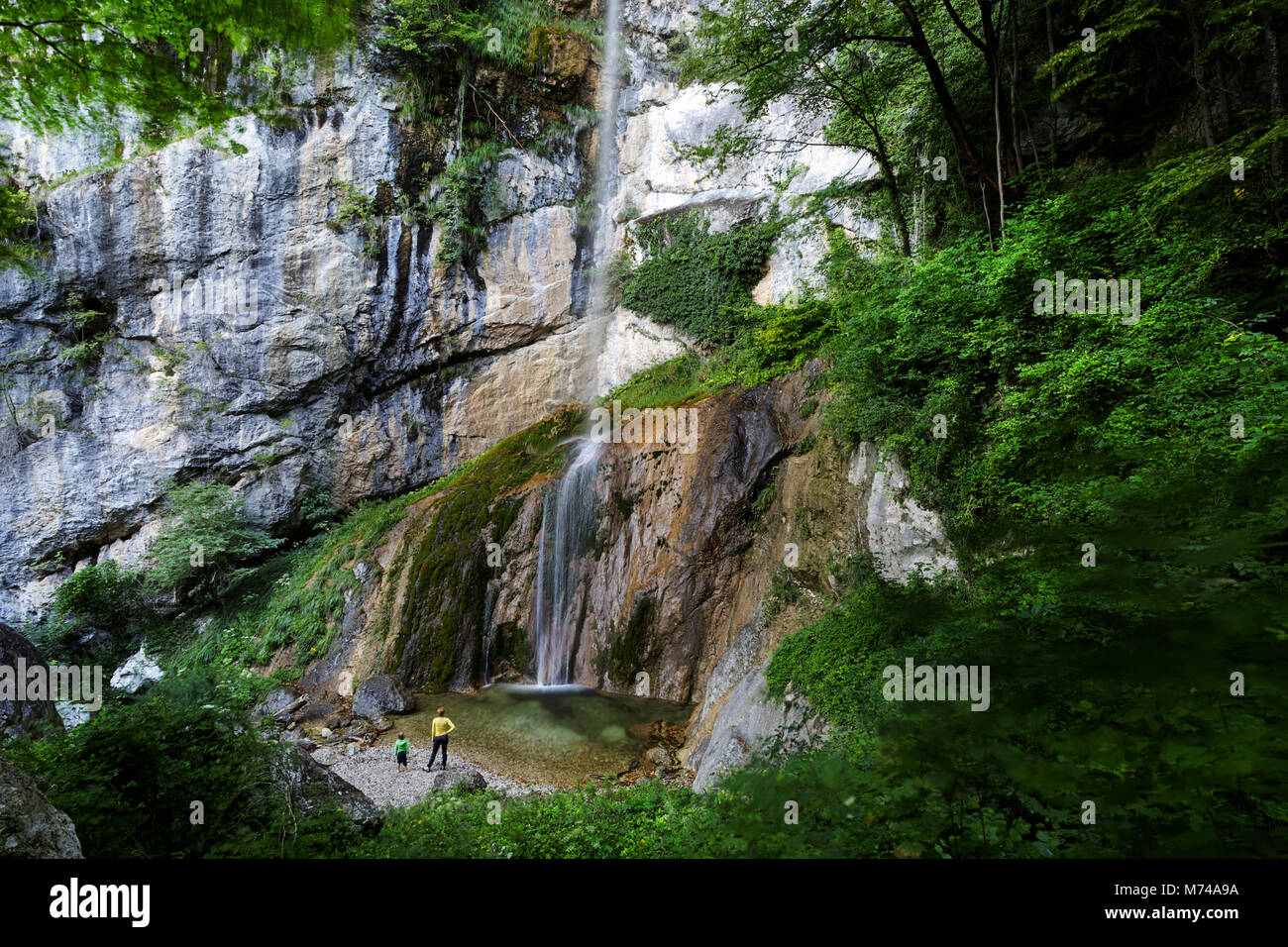 Mother and son touching with smiling faces in front of a beautiful ...