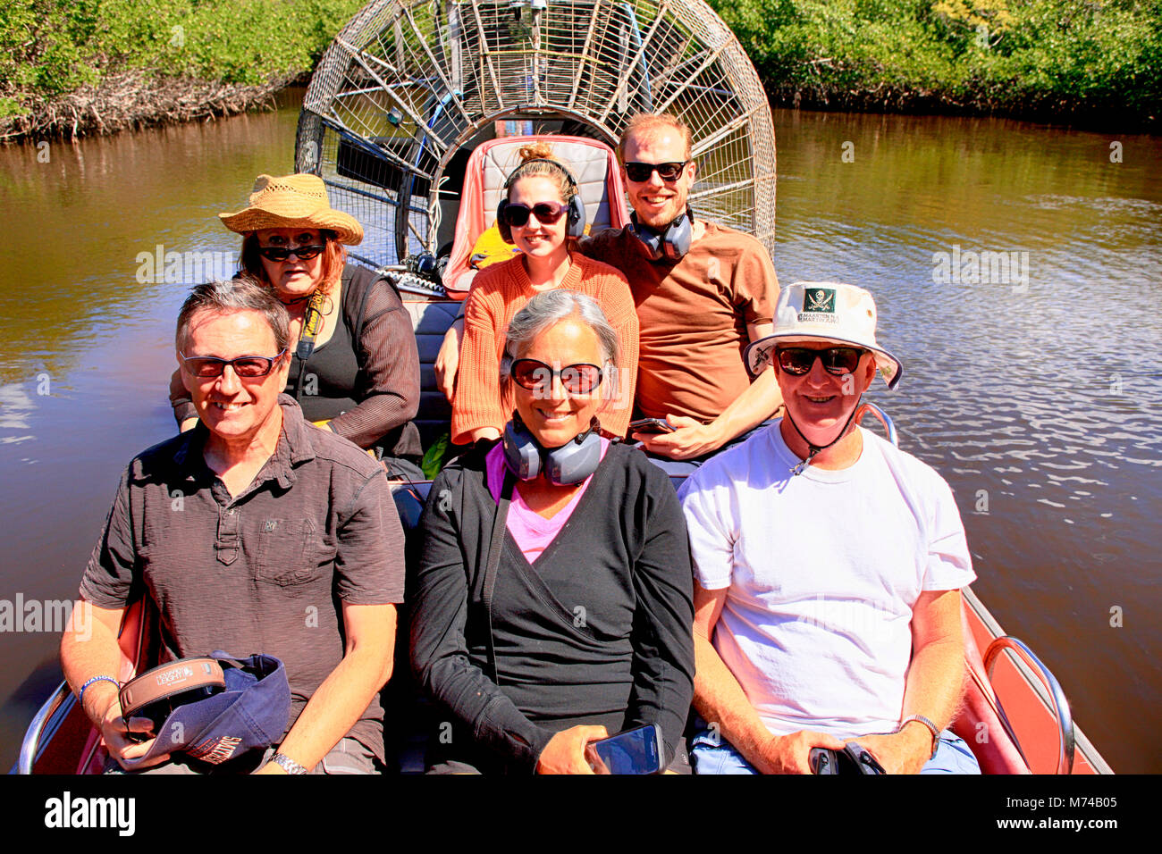 People aboard an airboat in the mangrove swamp around Everglades City ...