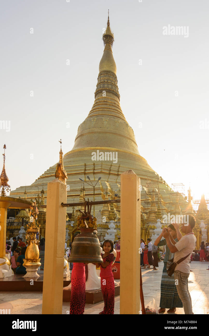 Yangon (Rangoon): Shwedagon Pagoda, people cast on bell, , Yangon ...