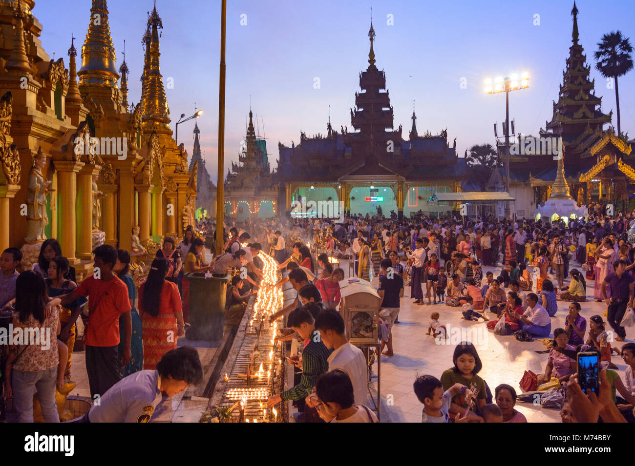 Yangon (Rangoon): Shwedagon Pagoda: people woman women lighting candles ...