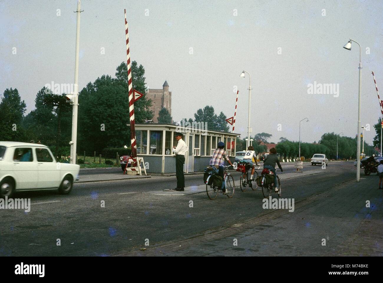 A guard stands and monitors vehicle and pedestrian traffic through a ...