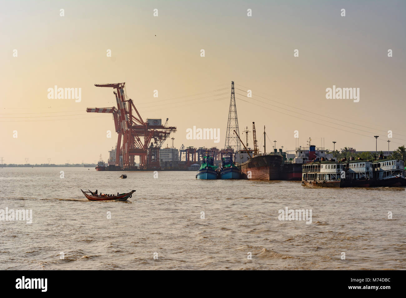 Yangon (Rangoon): Yangon River, rusty ship, port crane of Myanmar ...