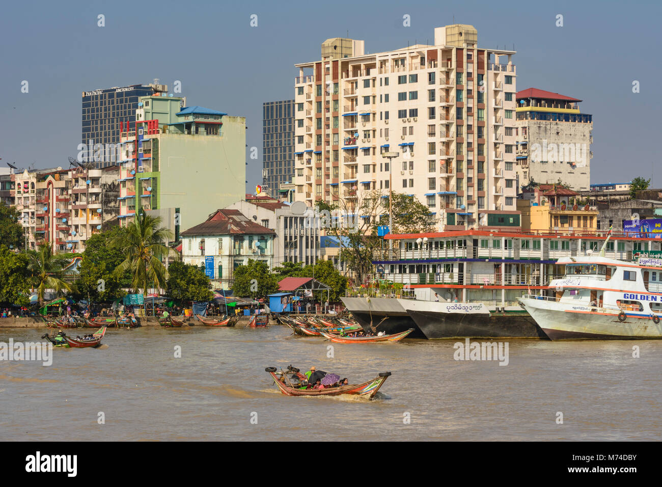 Yangon (Rangoon): Yangon River, city cenetr houses, small private ferry ...