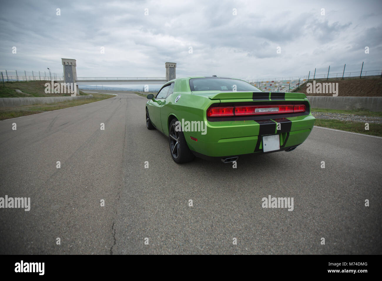 Green sport car track blue sky speed and extreme acceleration Stock ...