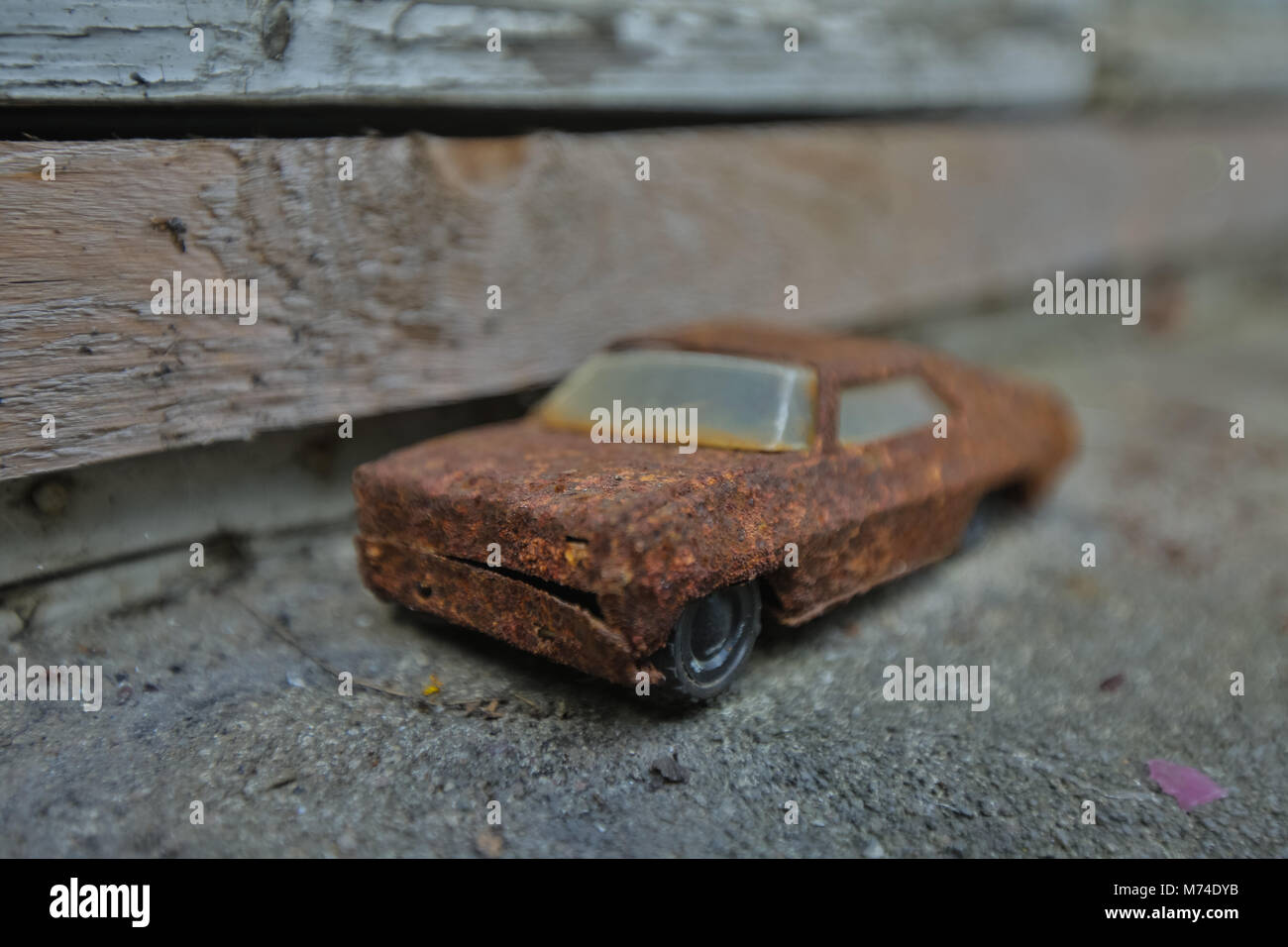 Rusty metalic car model macro shoot ner the window outdoor closeup ...