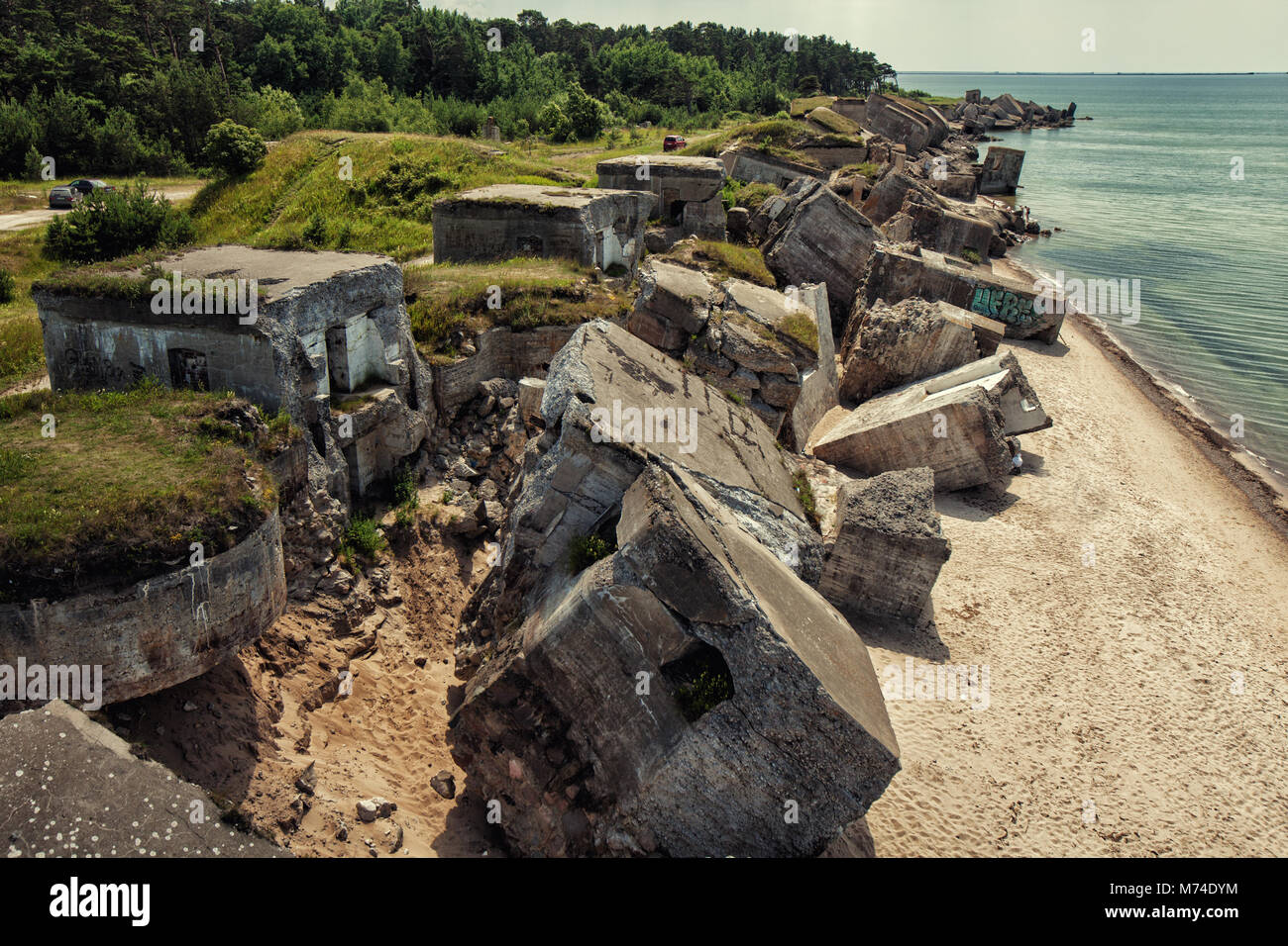 Blown up german military forts on the beach under blue sky drone photo ...