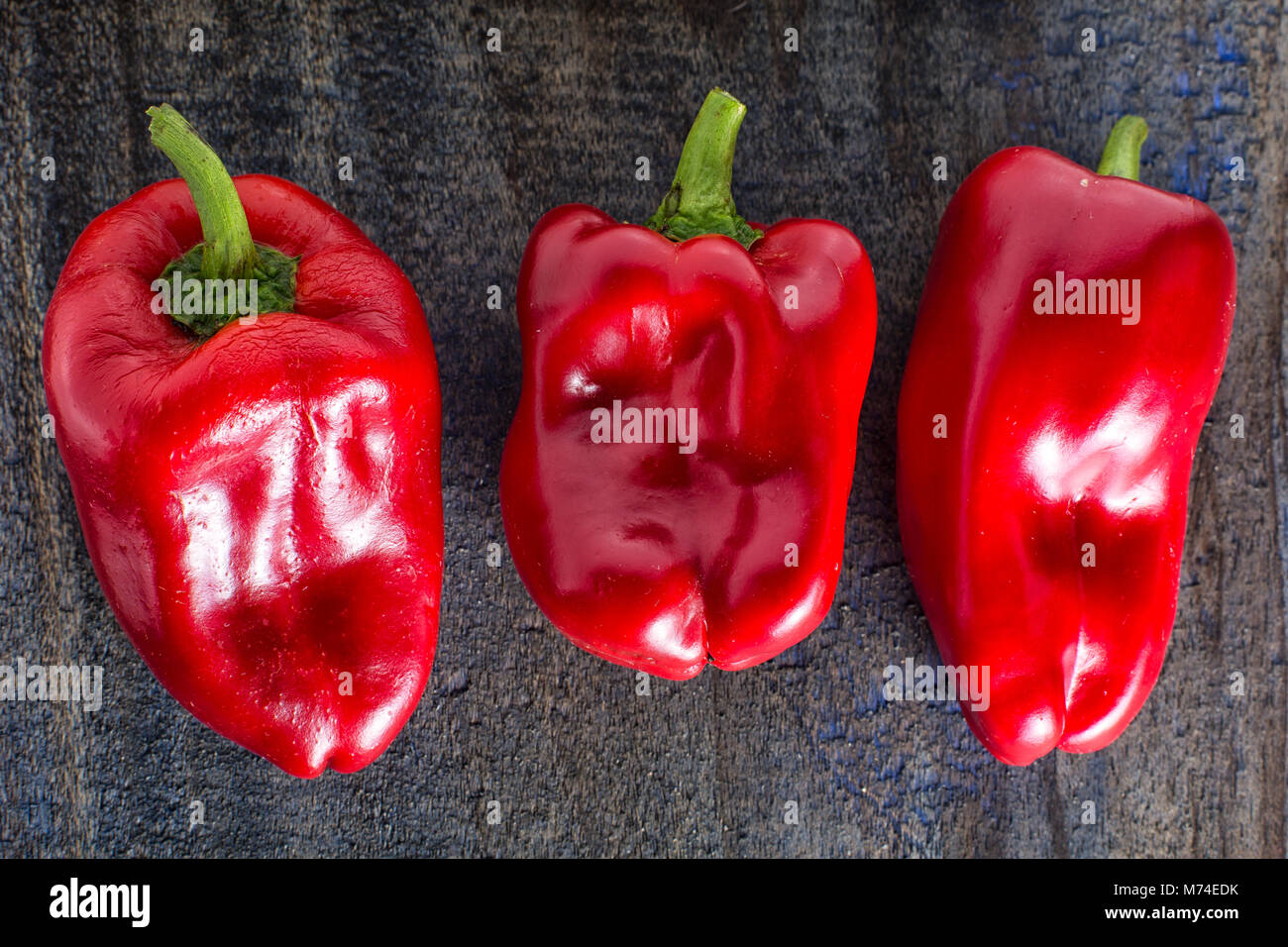 small red peppers on rustic background in Ecuador Stock Photo - Alamy