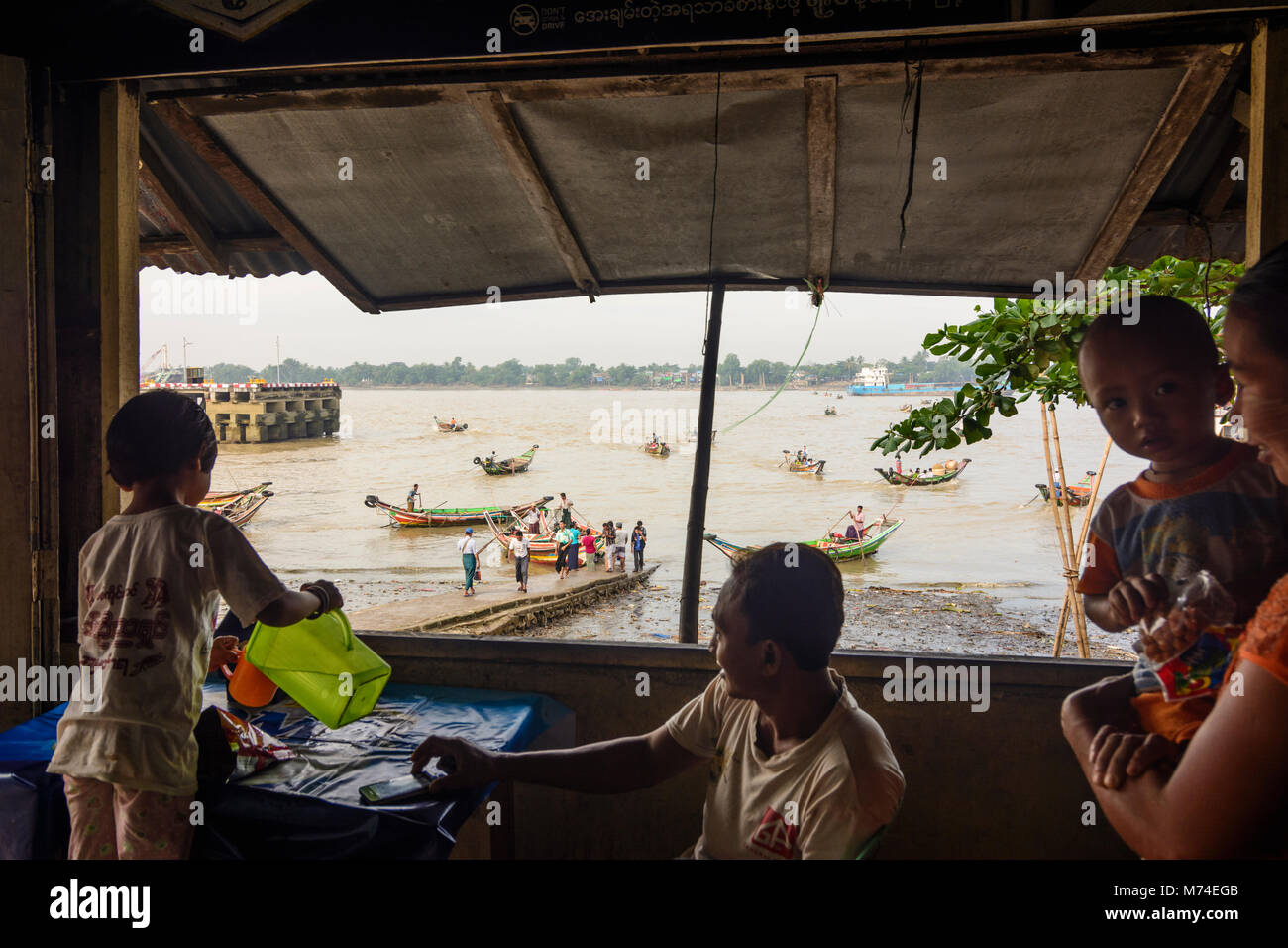 Yangon (Rangoon): family at restaurant, small private ferry boat boats ...