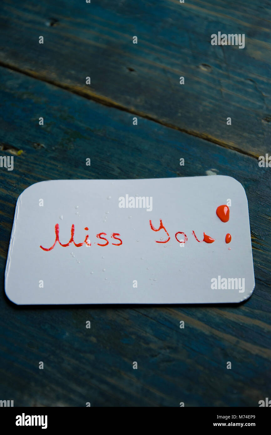 "Miss you" card on wooden blue table, space for text Stock Photo - Alamy