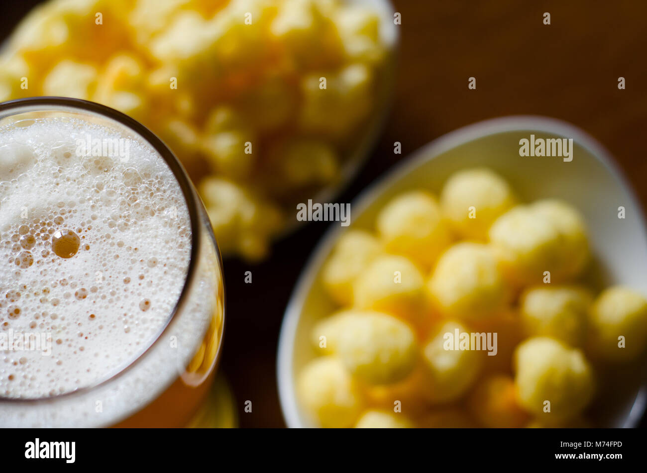 pint of lager beer in a glass, set of various snacks, a standard set of ...