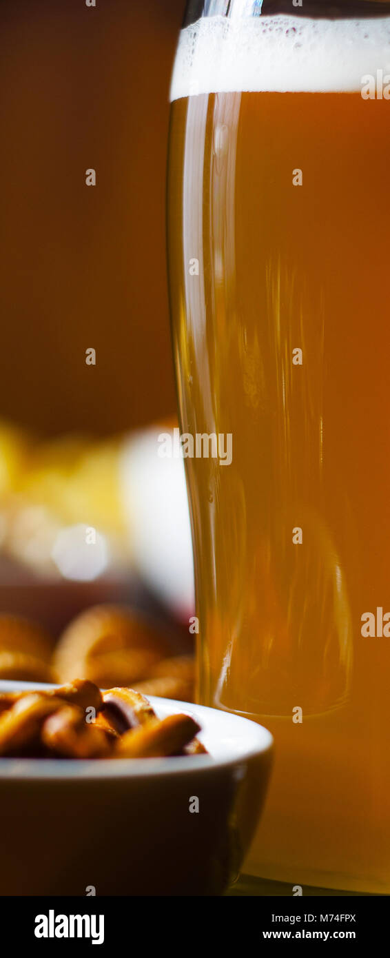 pint of lager beer in a glass, set of various snacks, a standard set of ...