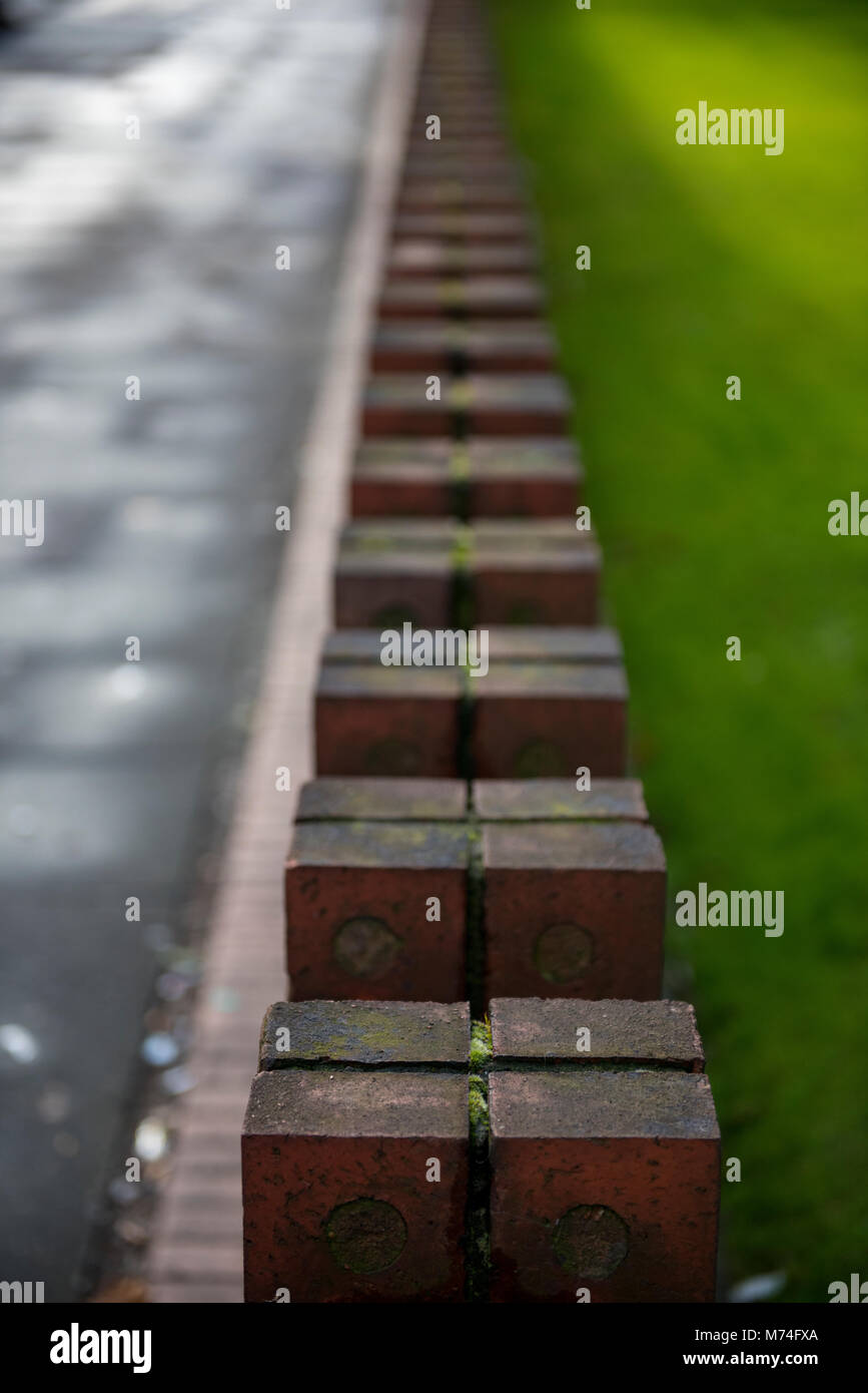 a brick wall in a garden separating the footpath from a front garden ...