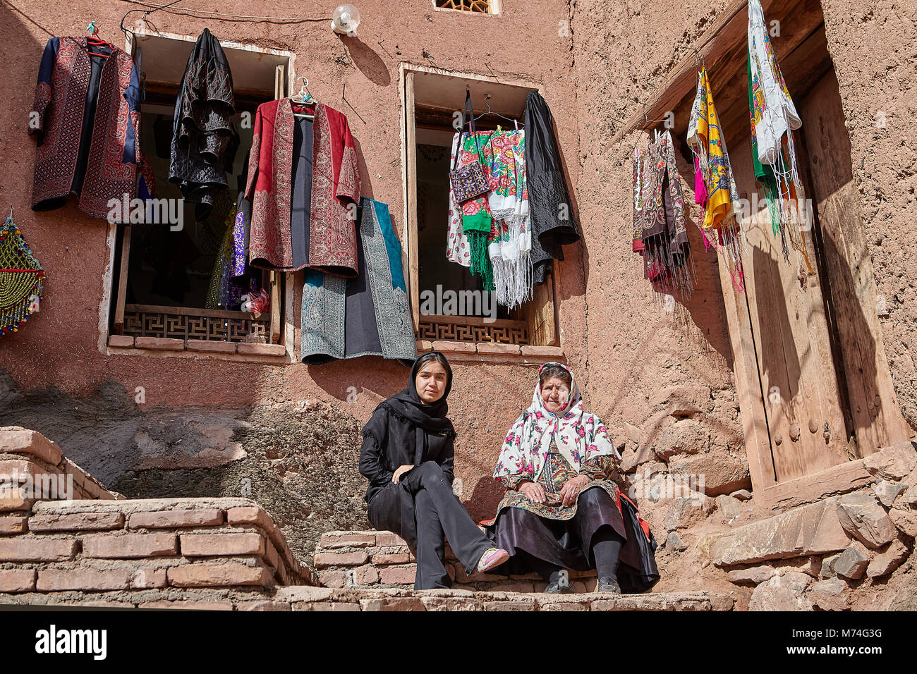 Abyaneh, Iran - April 26, 2017: two Iranian women in hijabs sit in ...