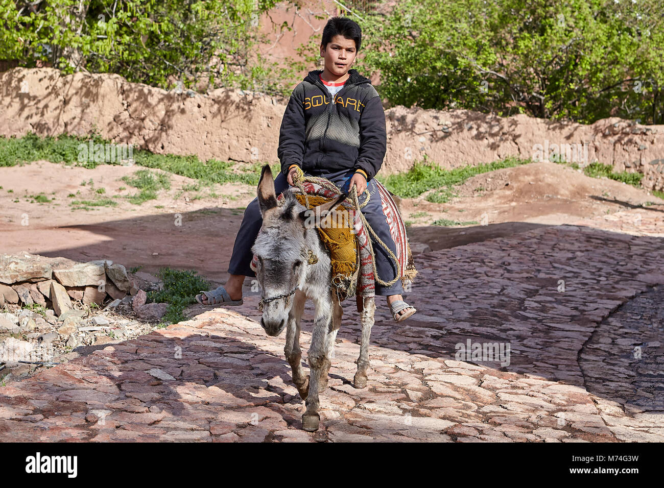 Abyaneh, Iran - April 26, 2017: Iranian boy is riding on a donkey in ...
