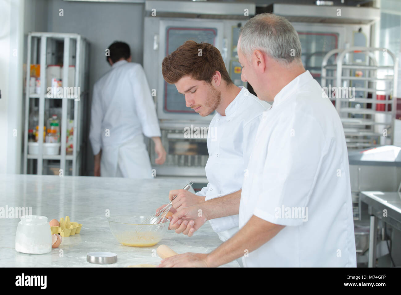 chef teaching trainee how to become a pastry chef Stock Photo - Alamy