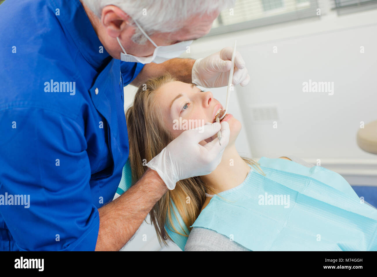 dentist checking patients teeth with a mirror and probe Stock Photo - Alamy