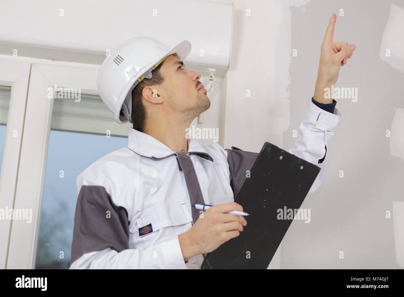 young civil engineering check a concrete wall Stock Photo - Alamy