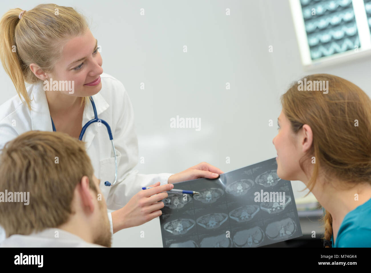 female professional taking xray of patient Stock Photo - Alamy