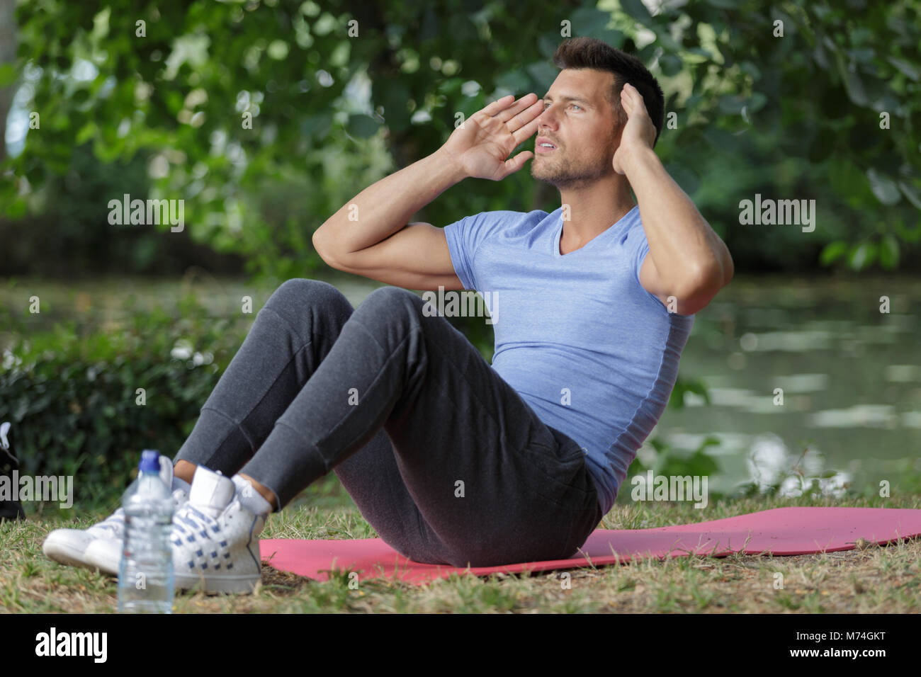 man doing sit-ups in the forest Stock Photo - Alamy