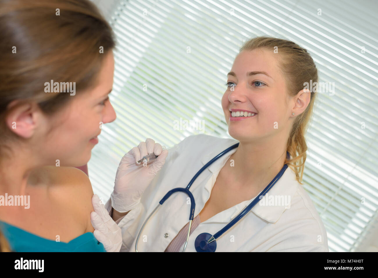 friendly female doctor in conversation with patient Stock Photo - Alamy