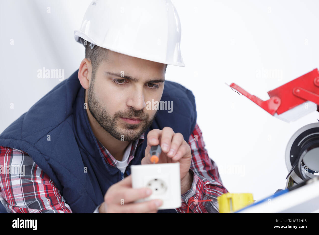 electrician installing socket in new house Stock Photo - Alamy